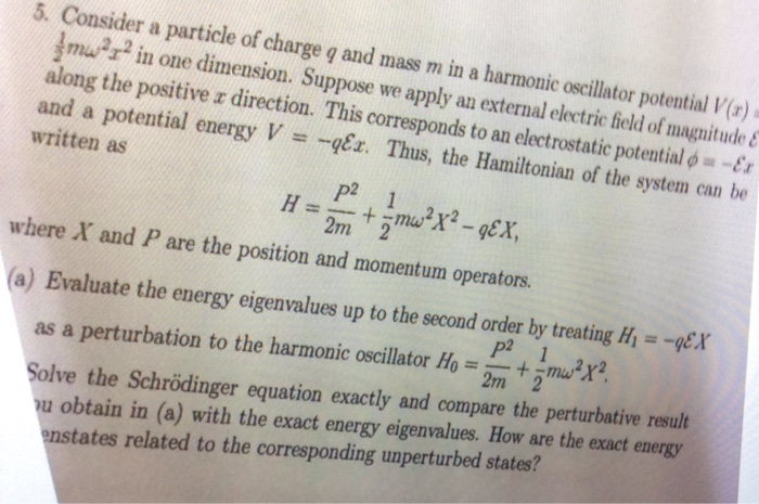 Solved Consider a particle of charge q and mass m in a | Chegg.com