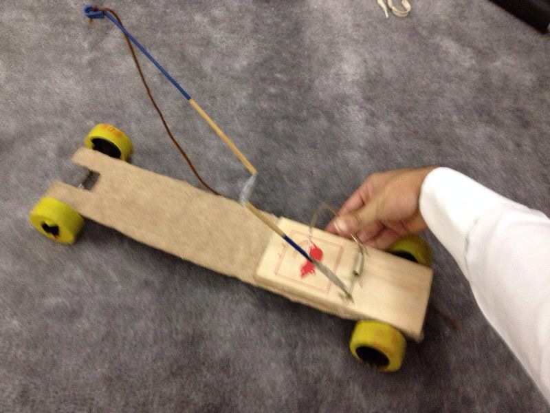 Solved a mouse trap car the wight the car is 0.115 kg, the | Chegg.com