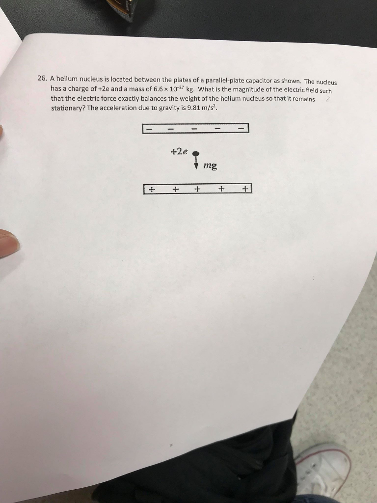 Solved 26. A helium nucleus is located between the plates of | Chegg.com
