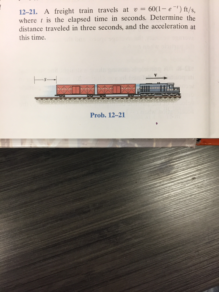 Solved 12-21. A freight train travels at v = 60(1- e") ft/s. | Chegg.com